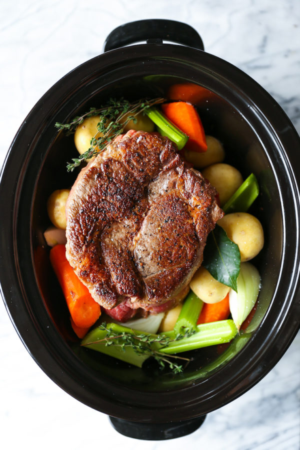 Do veggies go under meat in slow cooker?
