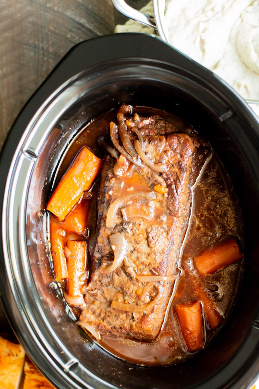 Do you add water to slow cooker when cooking brisket?