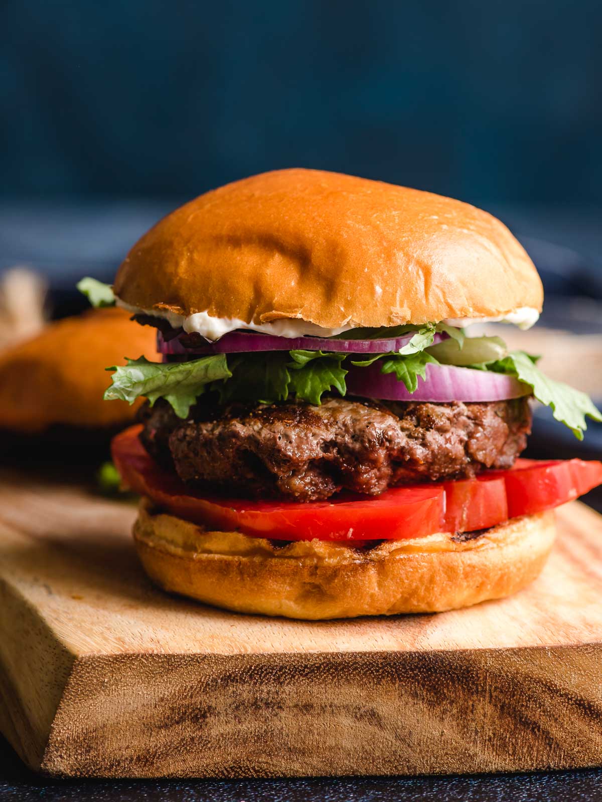 How can I add flavor to my grilled burgers?