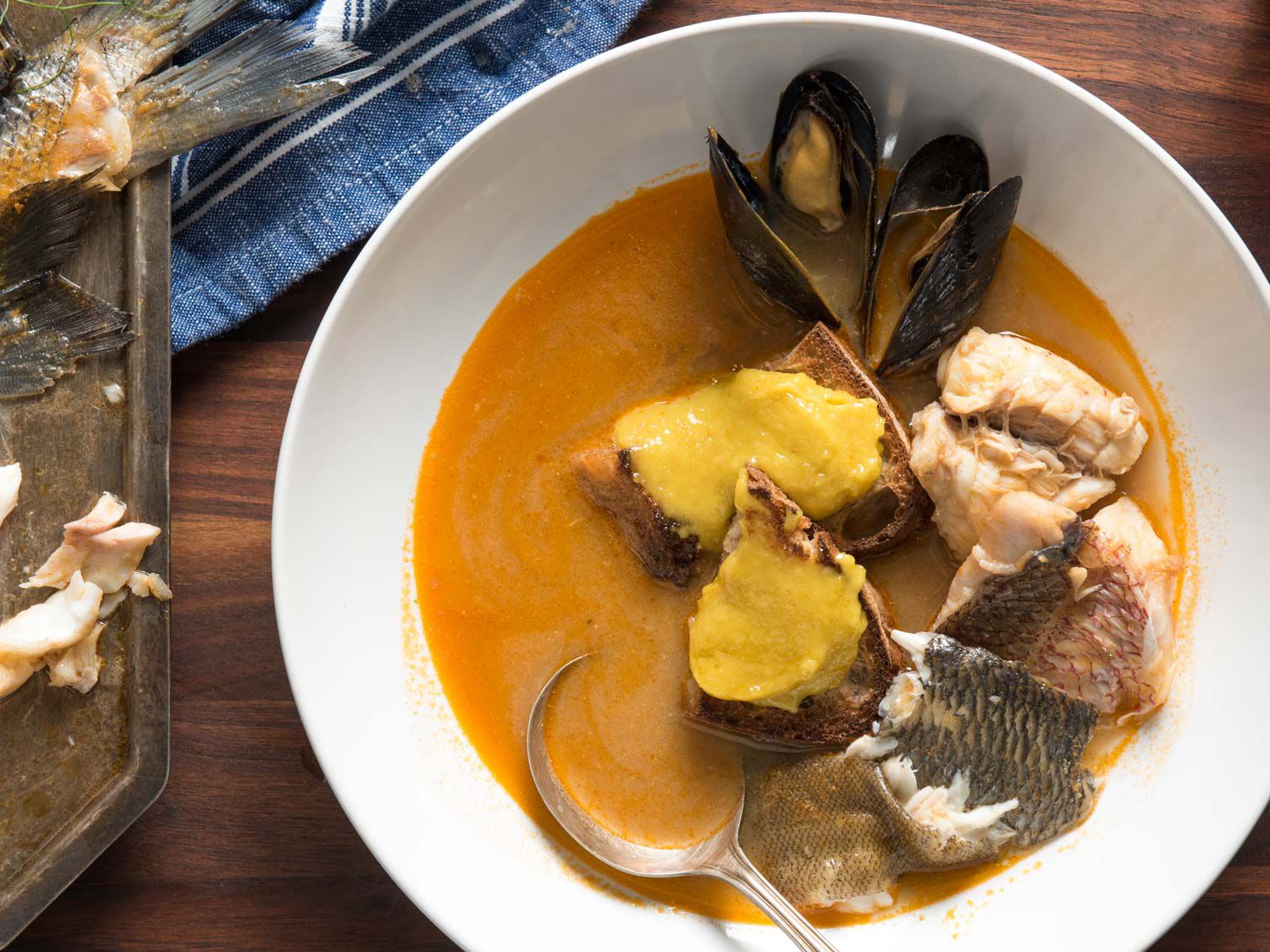 How is bouillabaisse eaten?