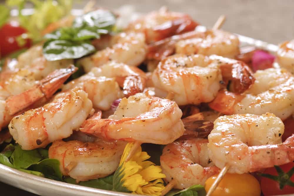 How long can cooked shrimp be left out at room temperature?