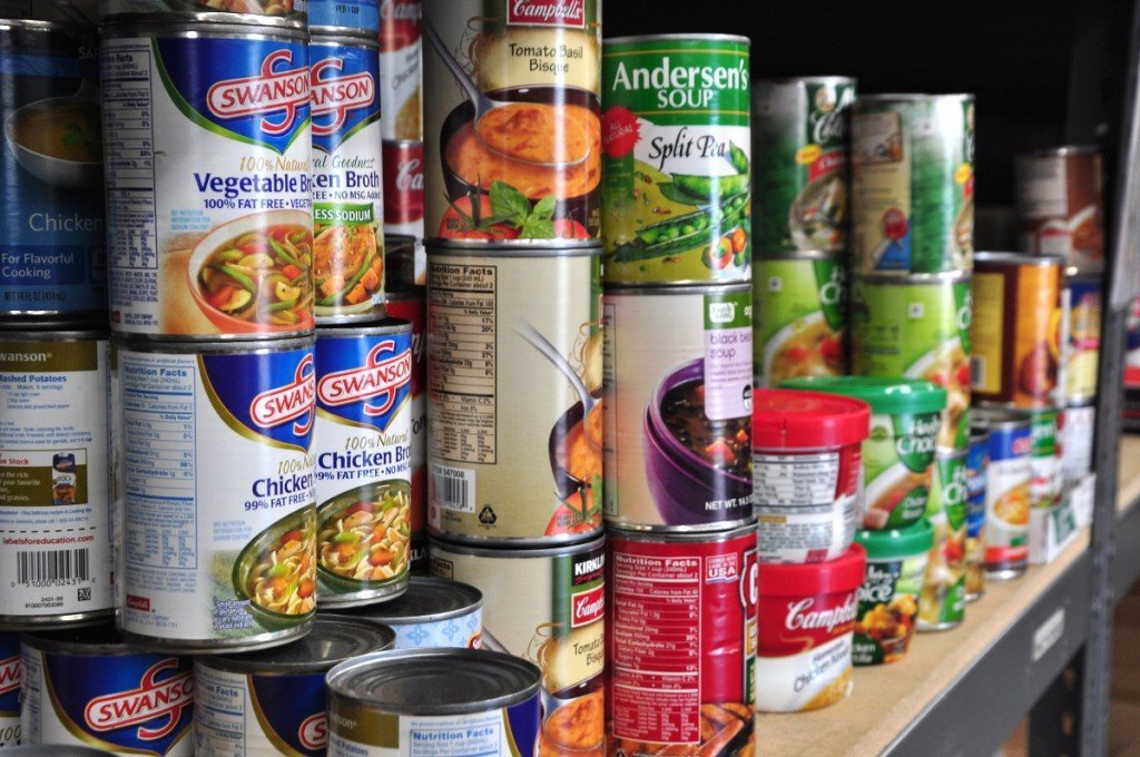 What can cause canned food to spoil?
