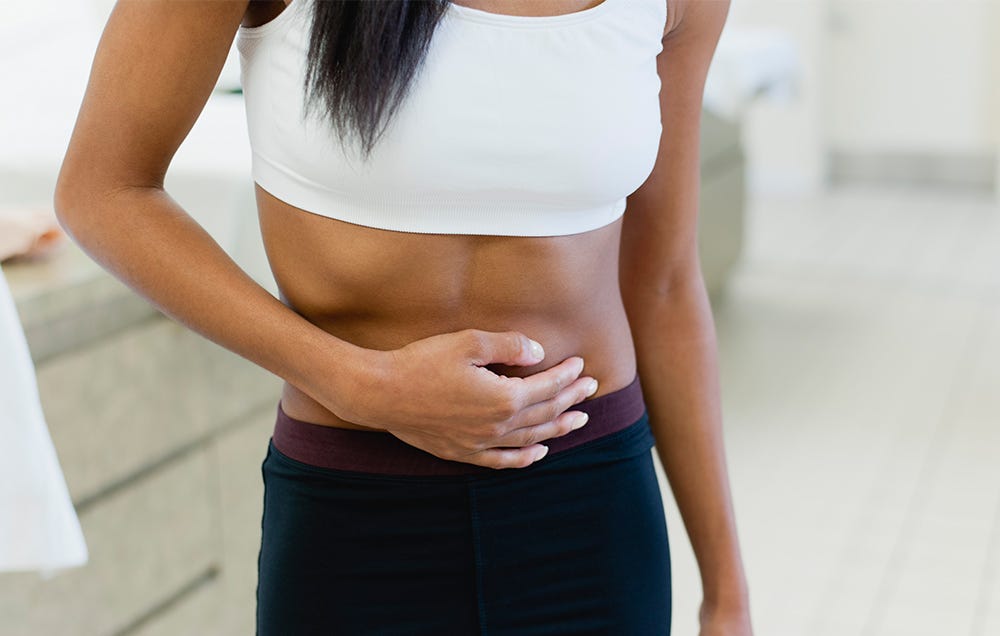 What can cause stomach pain for a woman?