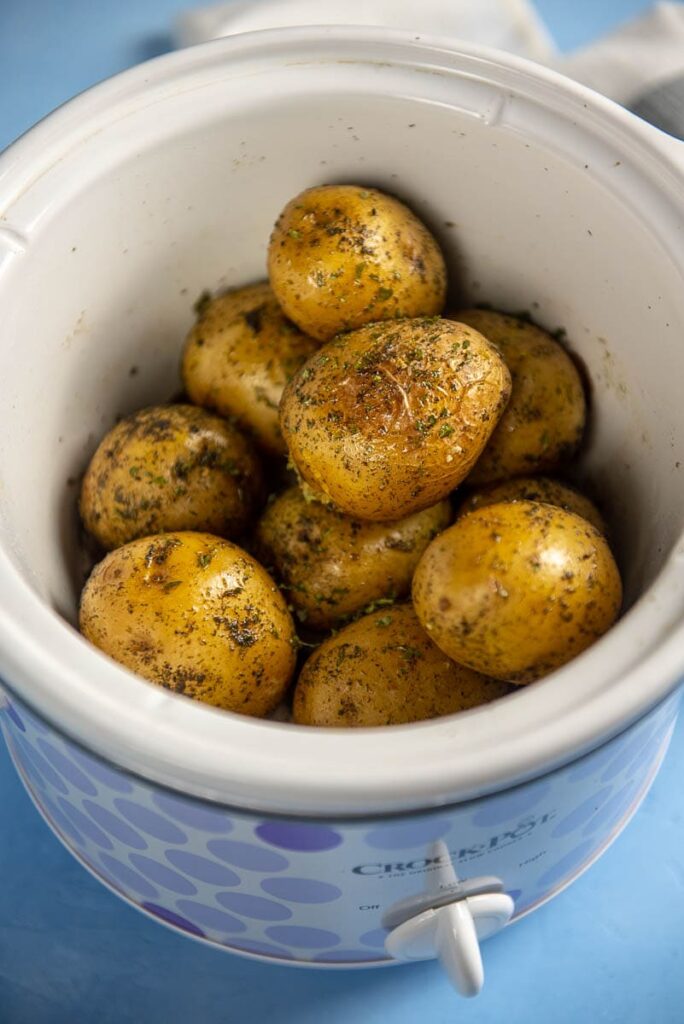 When should I add potatoes to slow cooker?